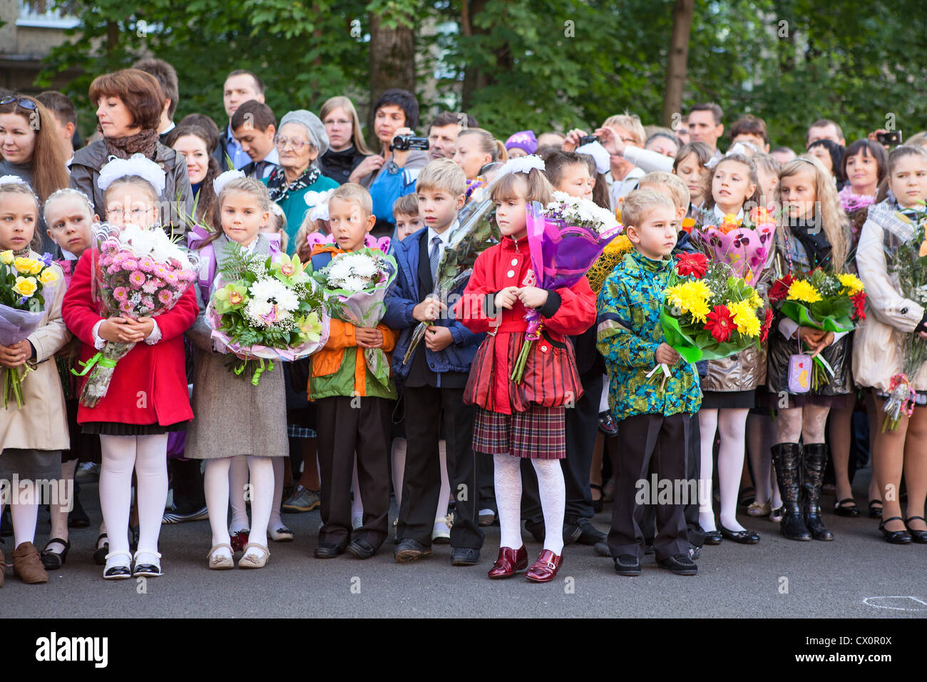 Many small Russian children begin school at first time. Solemn line ...
