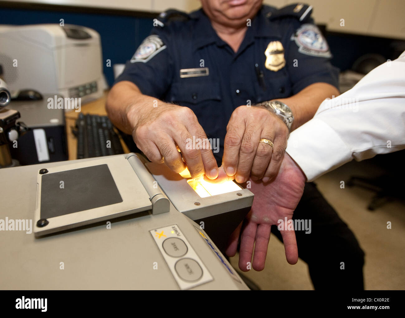 US Customs and Border Protection officer uses scanner to document and ...