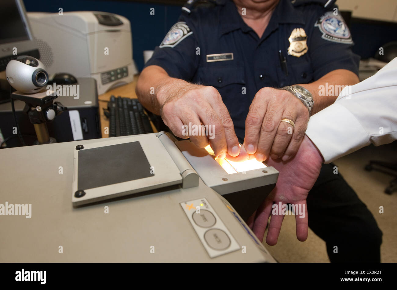 US Customs and Border Protection officer uses scanner to document and ...