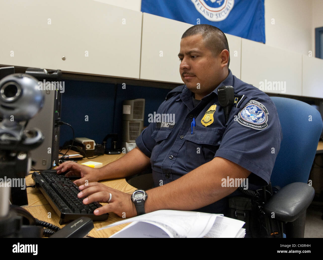 US Customs and Border Protection officers enter info into computer ...