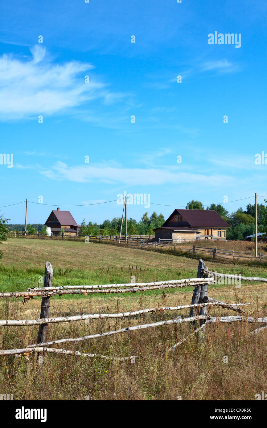 Contemporary Russian village with wooden houses and fence. Summer ...