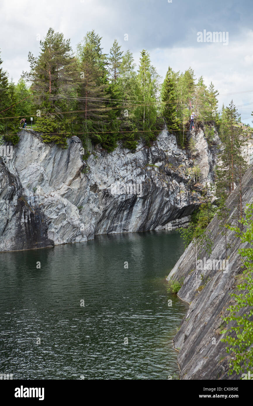 Transition the rope bridge over a flooded marble quarry in Ruskeala ...