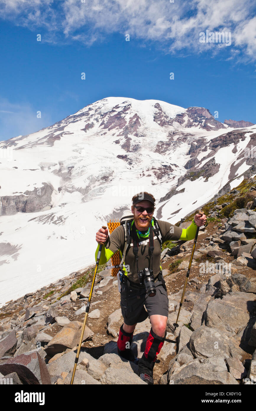 A young man hiking the Skyline Trail on Mount Rainier, Washington, USA ...