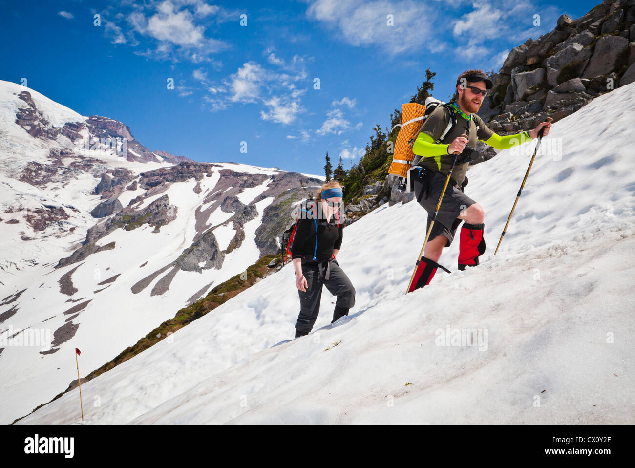 A man and woman make their way up Mount Rainier on the Skyline trail ...
