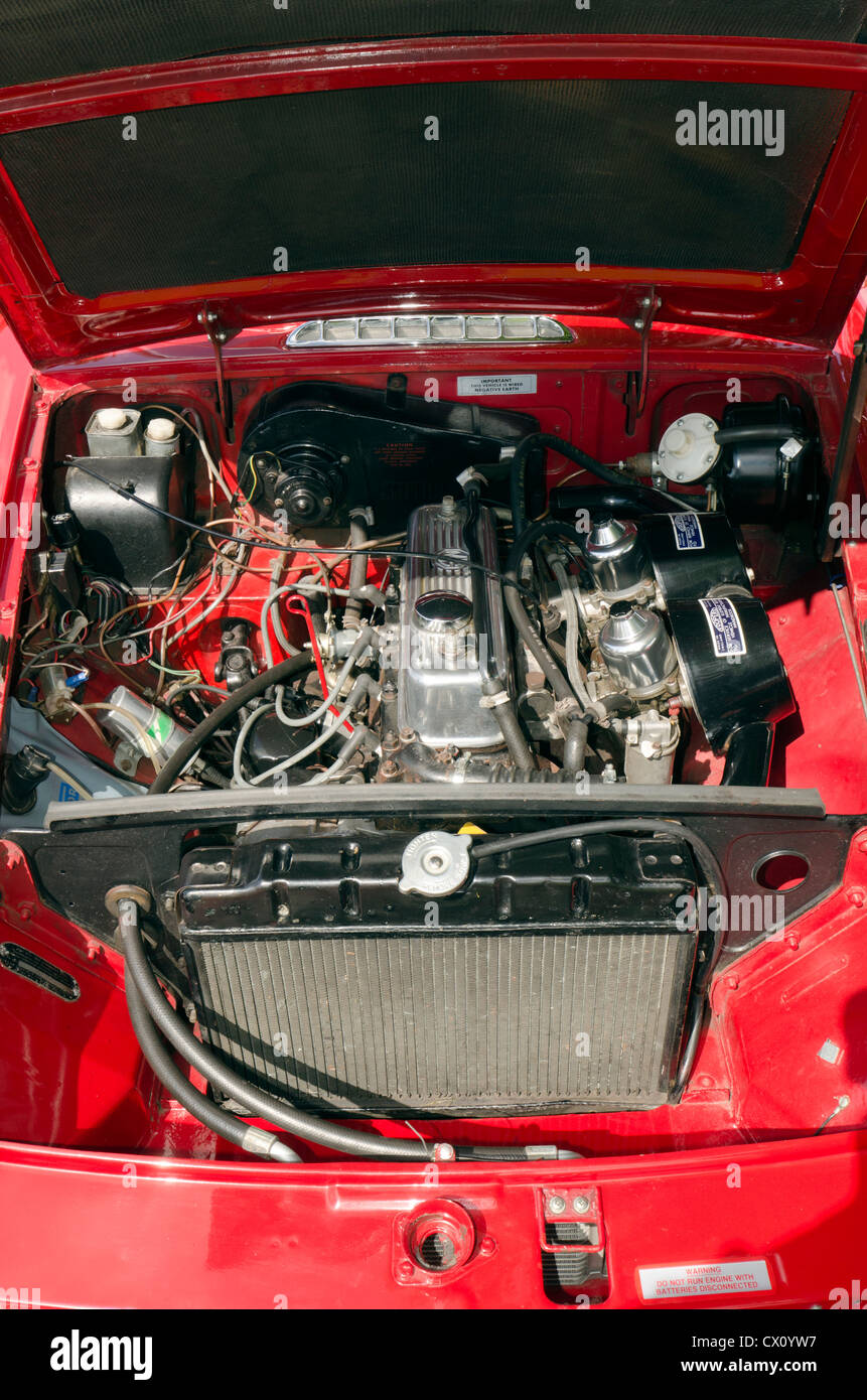Bonnet up revealing the engine compartment of a classic red MG sports ...