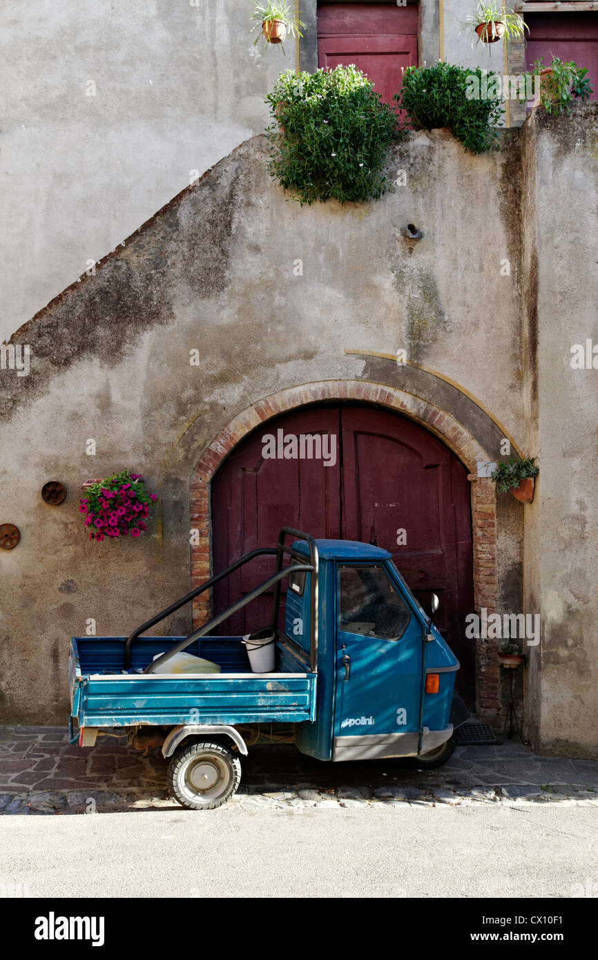Small Italian Ape truck parked in front of door, Laiatico Tuscany Italy ...