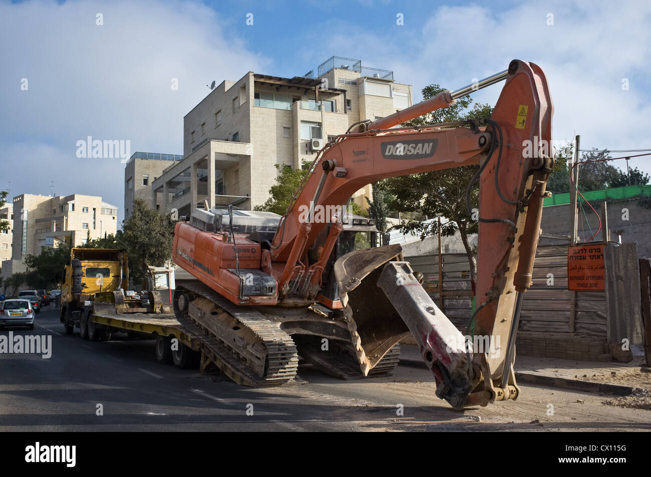 A Doosan DX340LC Hydraulic Excavator is loaded aboard a transport ...
