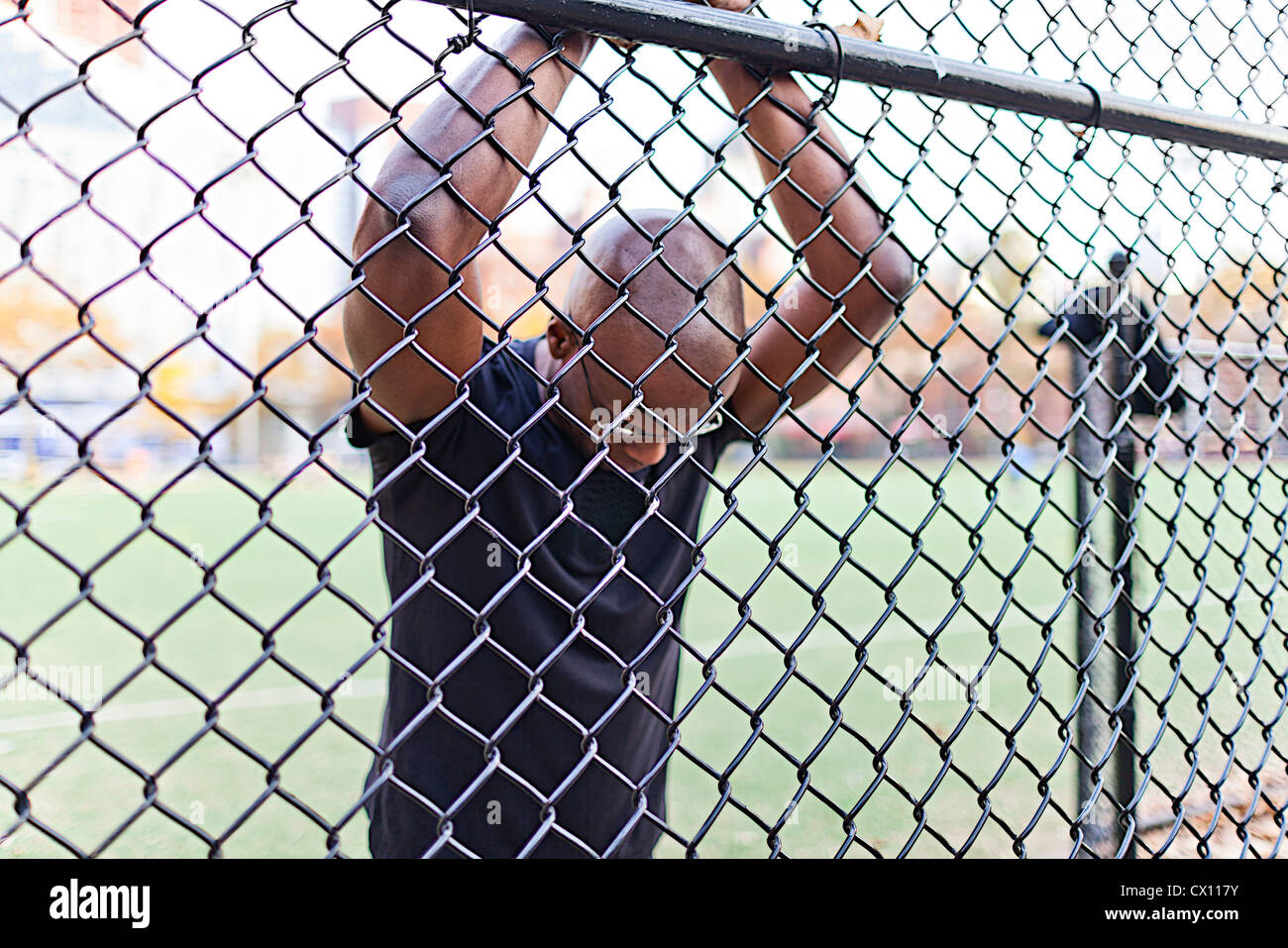 Man behind a chain link fence Stock Photo - Alamy