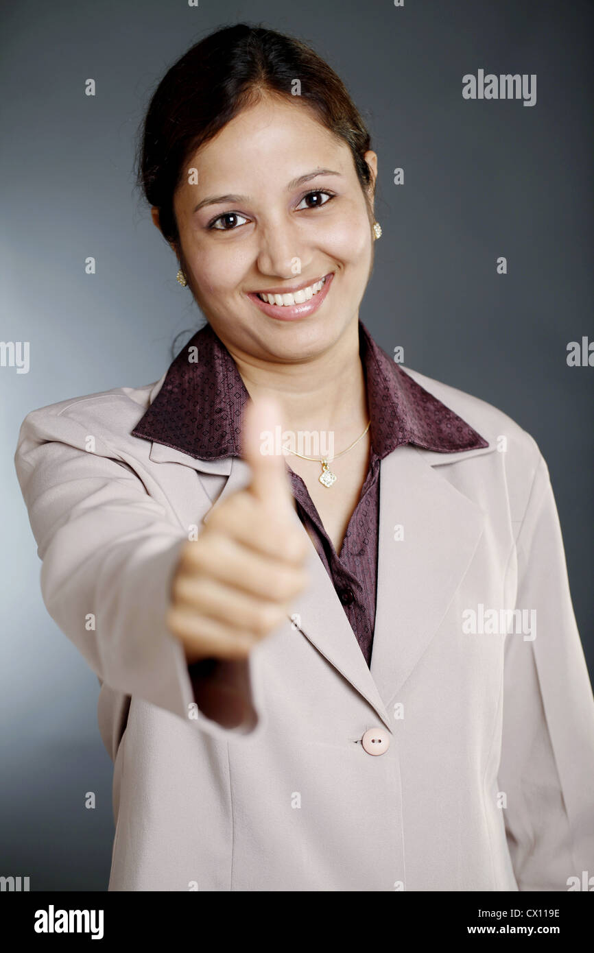 Happy Indian business woman showing thumbs up sign Stock Photo - Alamy