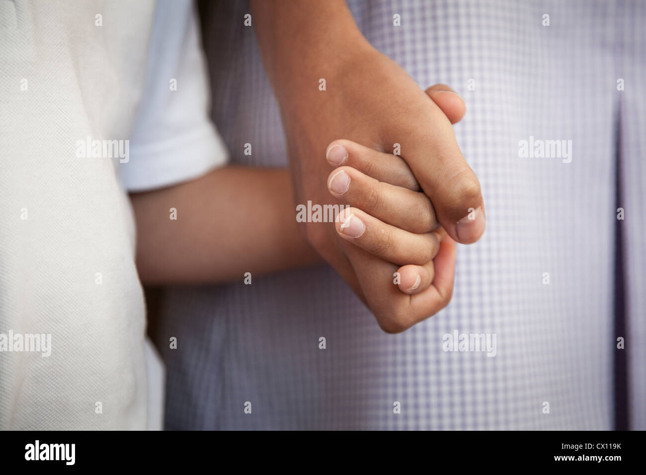 Sister And Older Brother Holding Hands