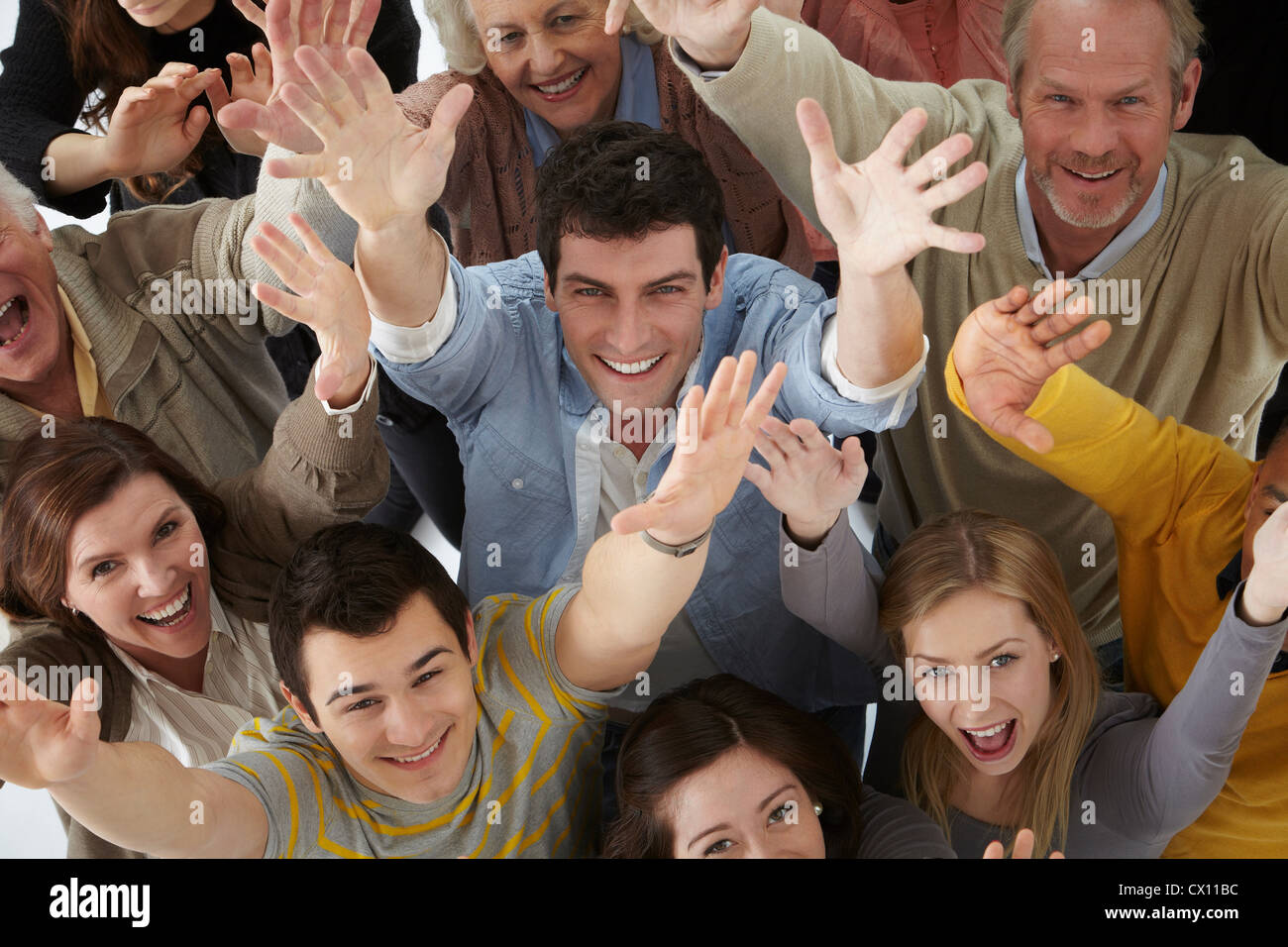Group of people with arms raised, high angle Stock Photo - Alamy