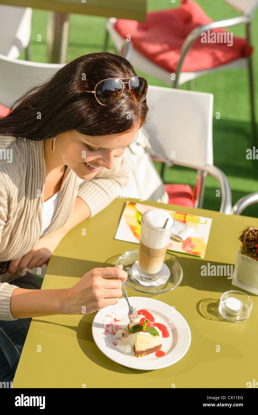 Woman eating cheesecake at cafe bar happy smiling restaurant dessert ...