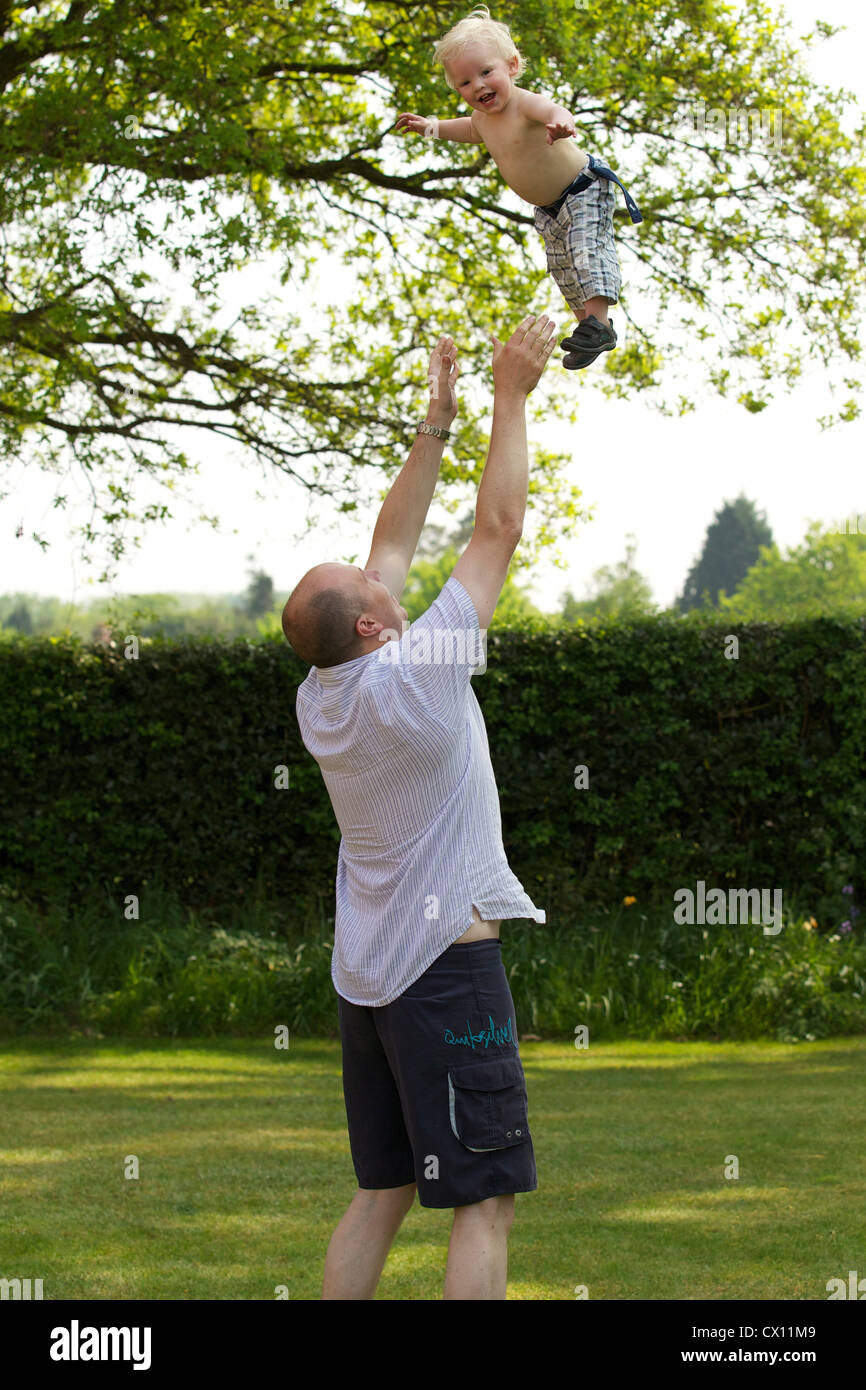 Father throwing young son in the air Stock Photo - Alamy