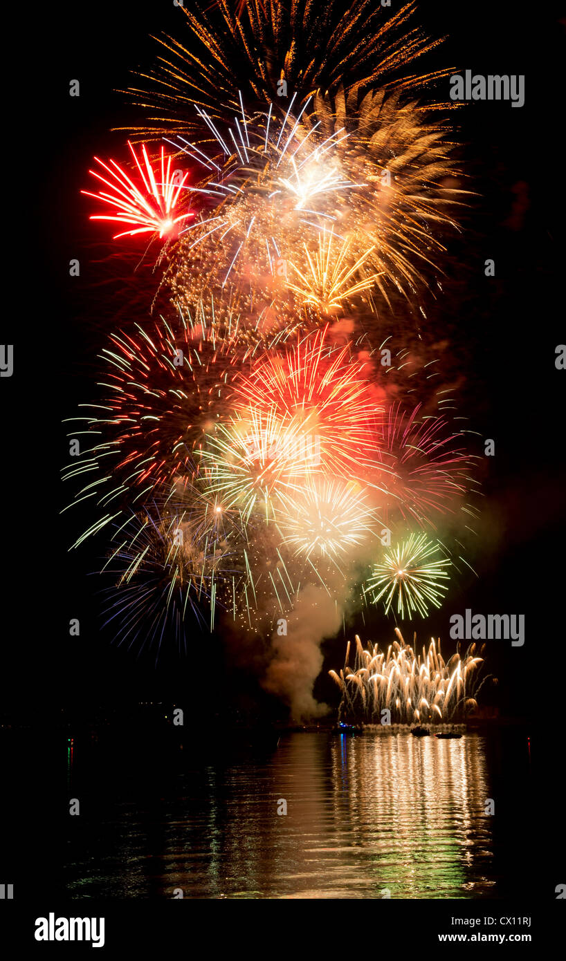 Firework display over water Stock Photo - Alamy