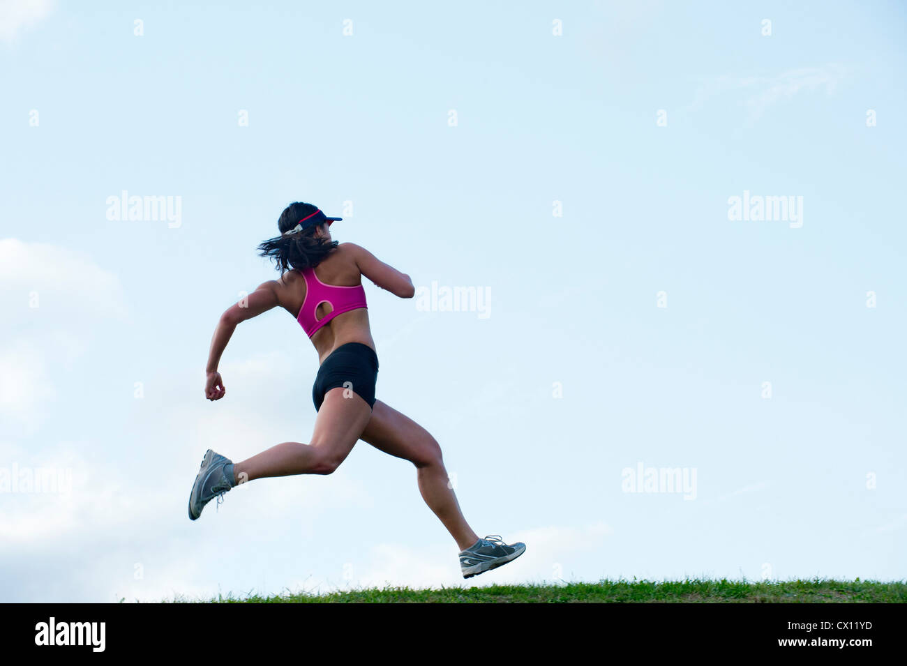 Young woman running Stock Photo - Alamy