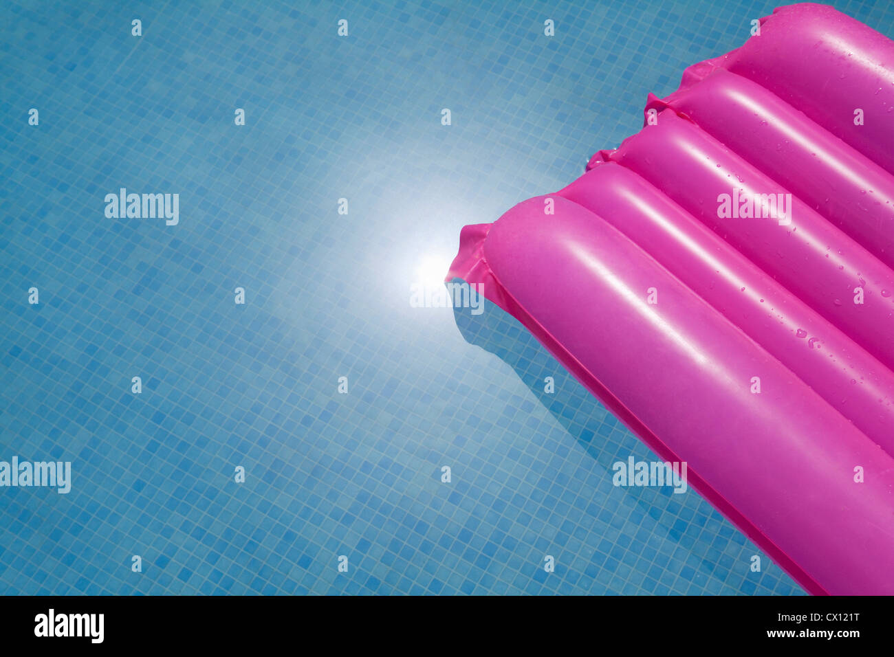 Pink inflatable in swimming pool Stock Photo - Alamy