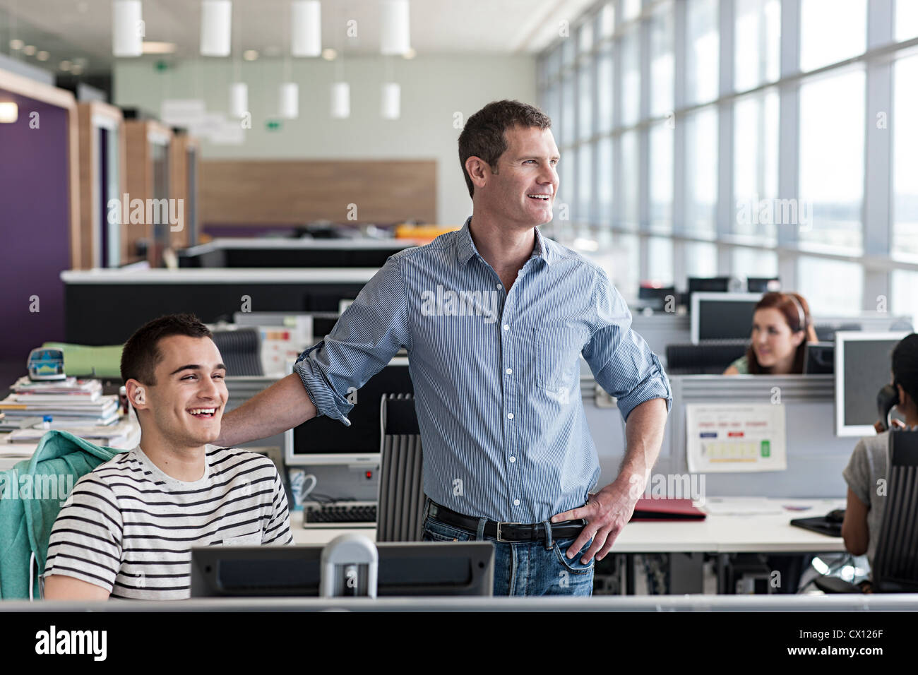 Two colleagues in office interior Stock Photo - Alamy