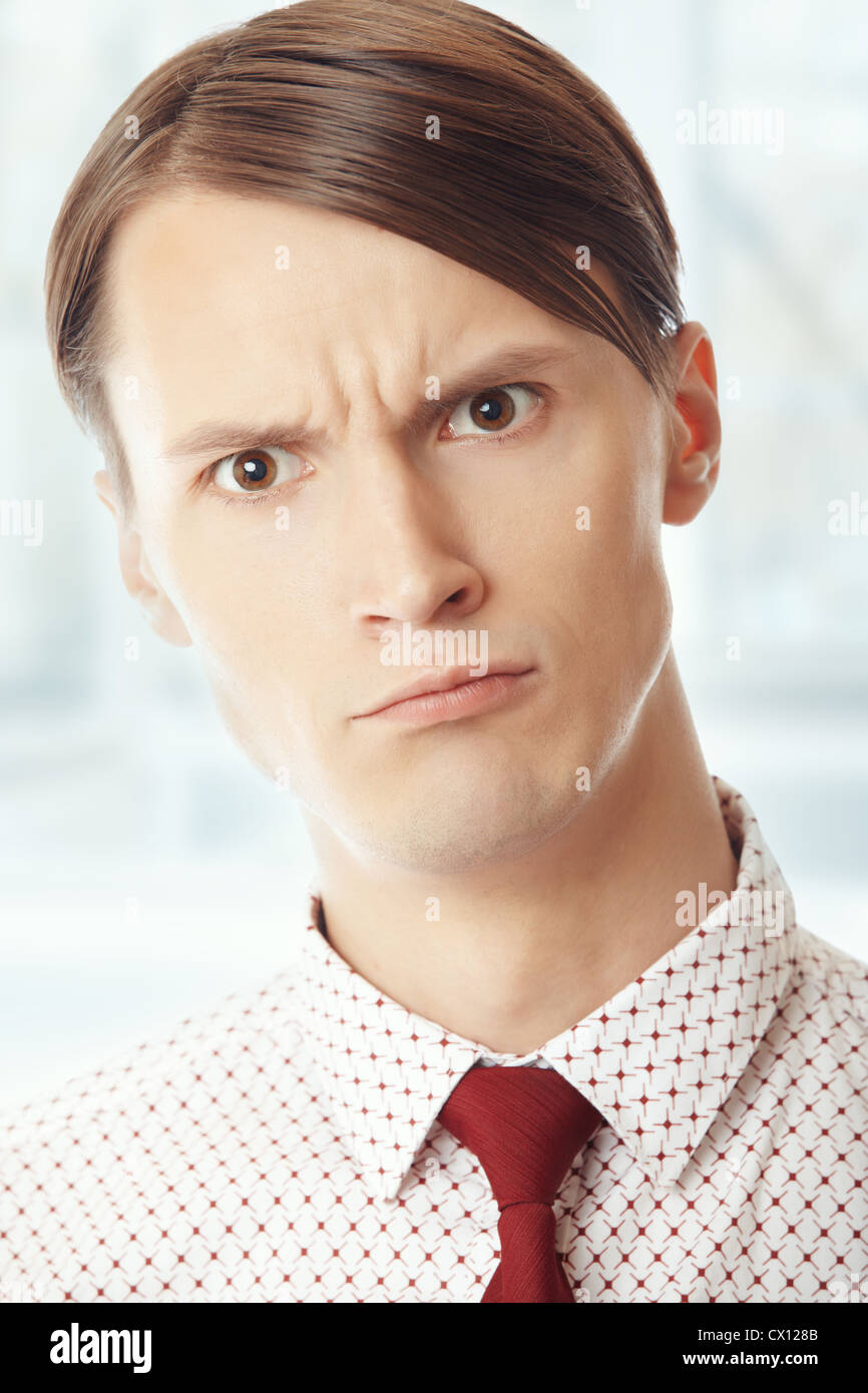 Displeased businessman at his office. Vertical portrait Stock Photo - Alamy