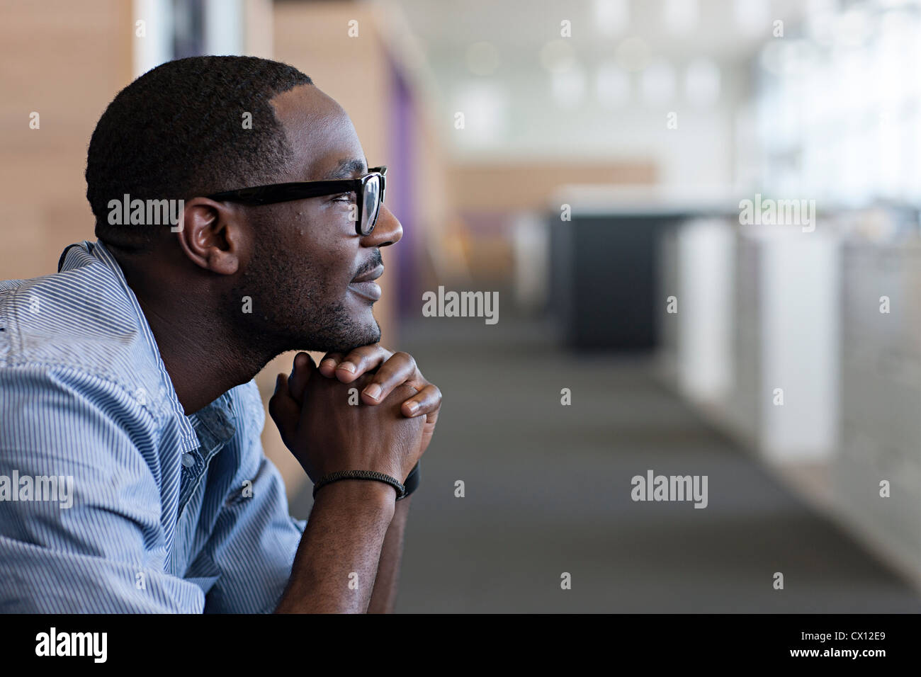 Man with hand on chin, side view Stock Photo - Alamy