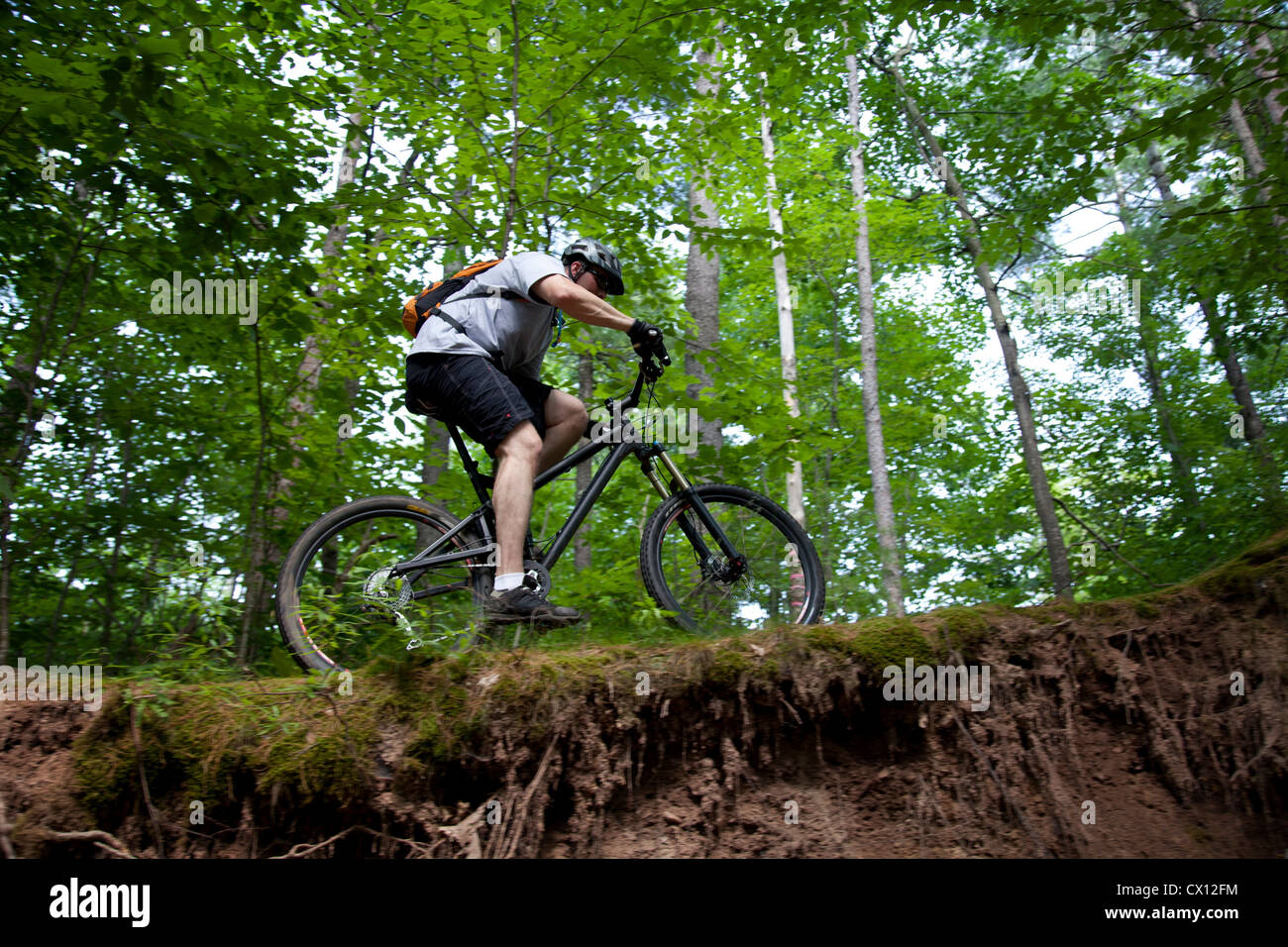 Man mountain biking on ledge Stock Photo - Alamy