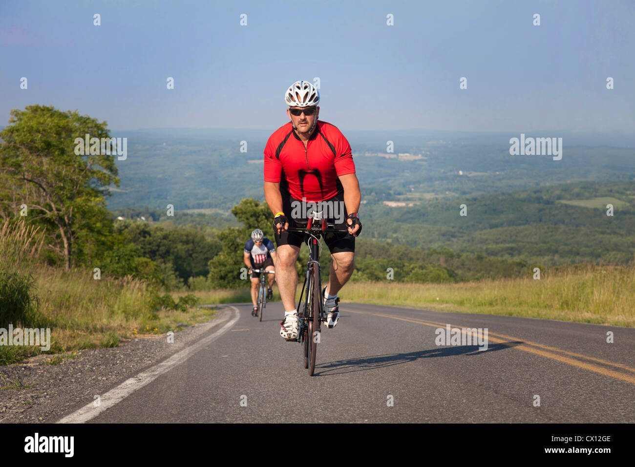 Men cycling on open road Stock Photo - Alamy