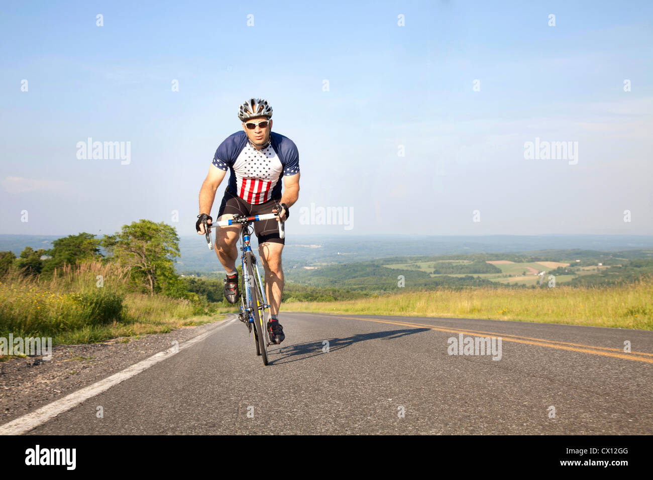 Man cycling on open road Stock Photo - Alamy