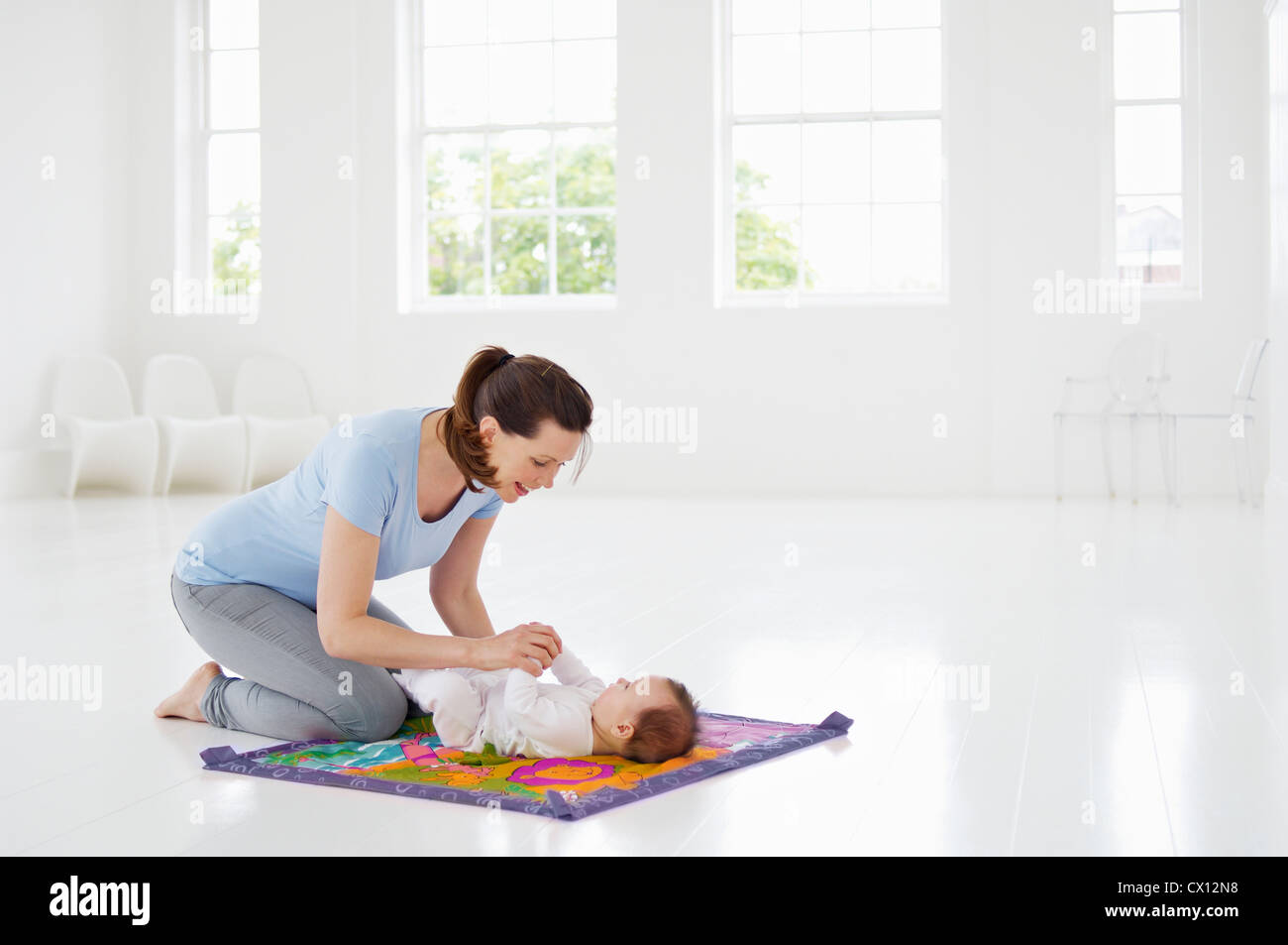 Mother and baby on play mat Stock Photo - Alamy