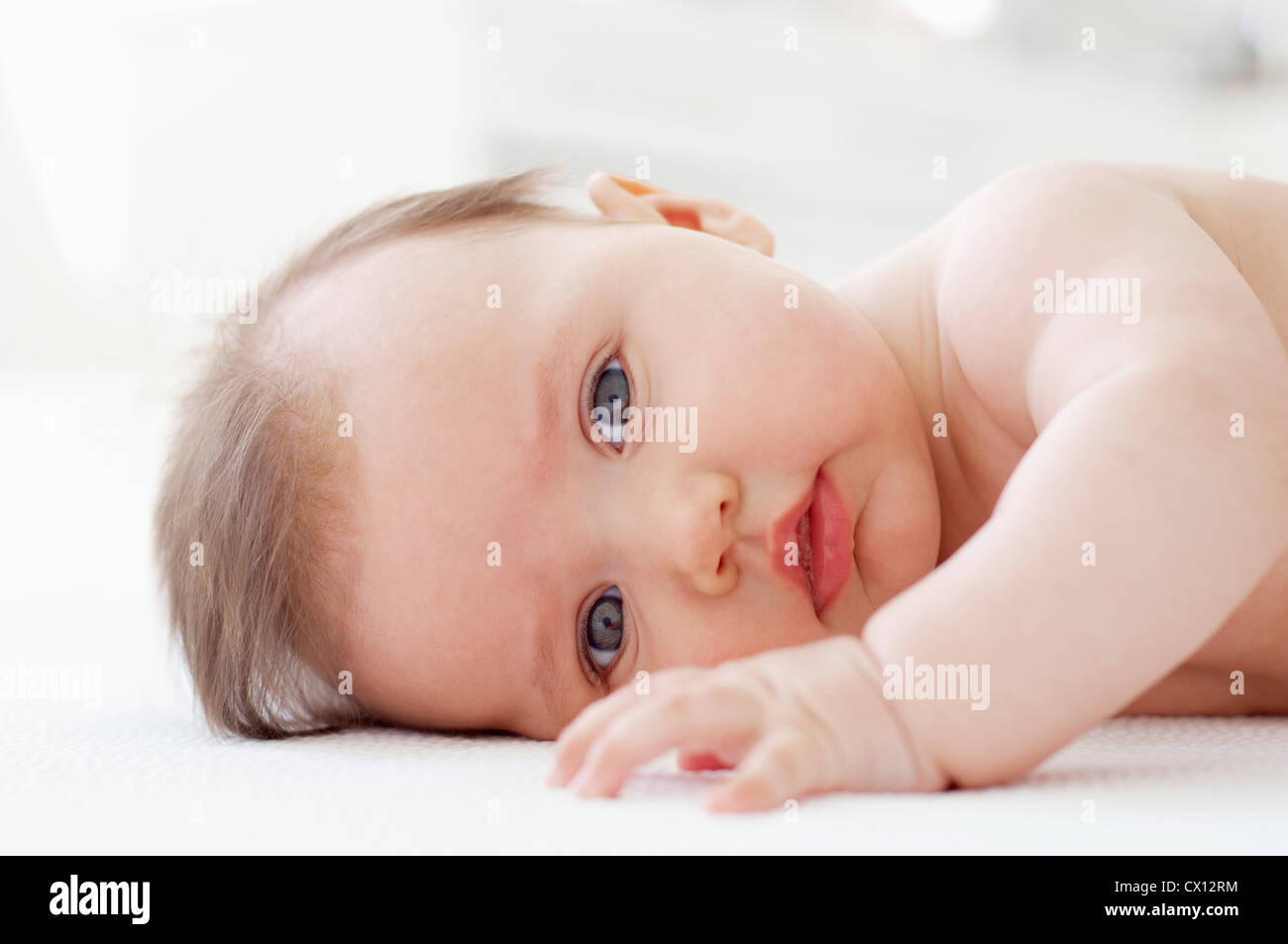 Baby girl, lying on side Stock Photo - Alamy