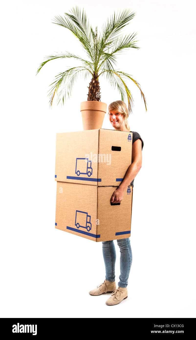Moving, symbol image. Woman is carrying moving boxes Stock Photo - Alamy