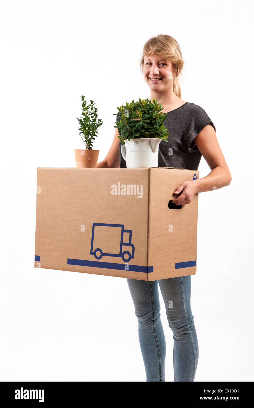 Moving, symbol image. Woman is carrying moving boxes Stock Photo - Alamy
