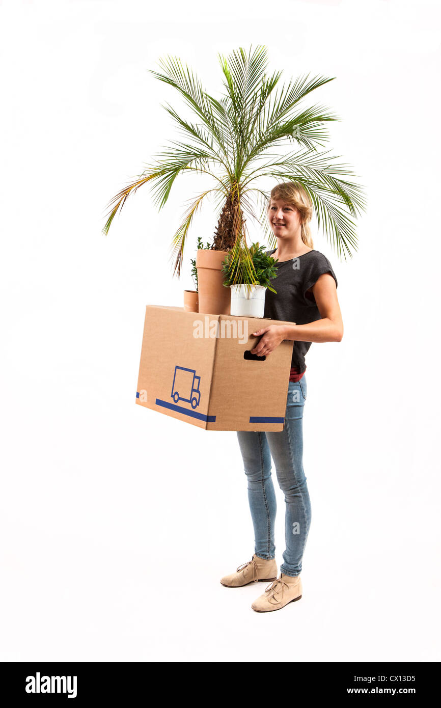 Moving, symbol image. Woman is carrying moving boxes Stock Photo - Alamy