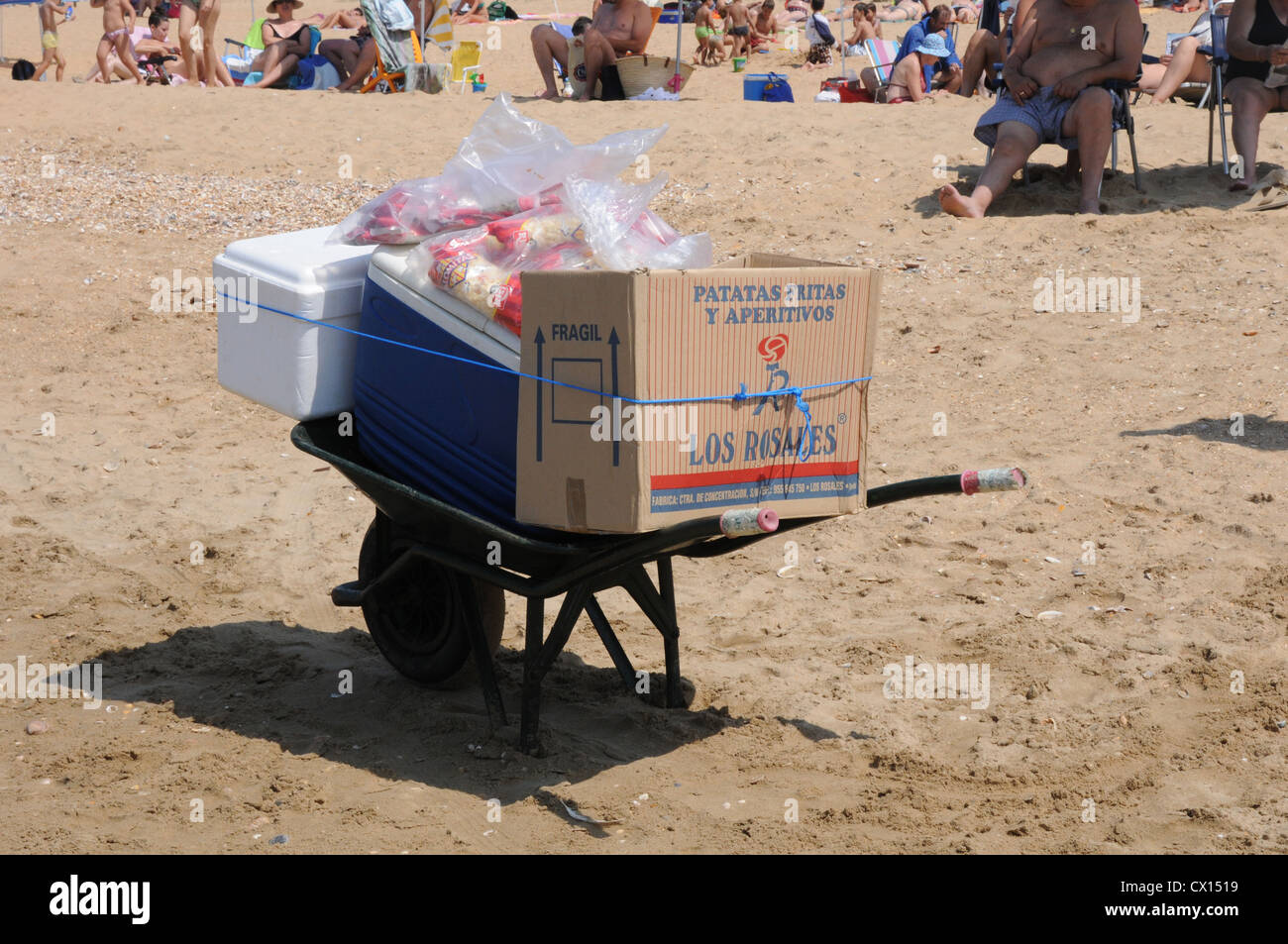 Wheelbarrow carrying products in boxes for sale on sandy beach, Punta ...