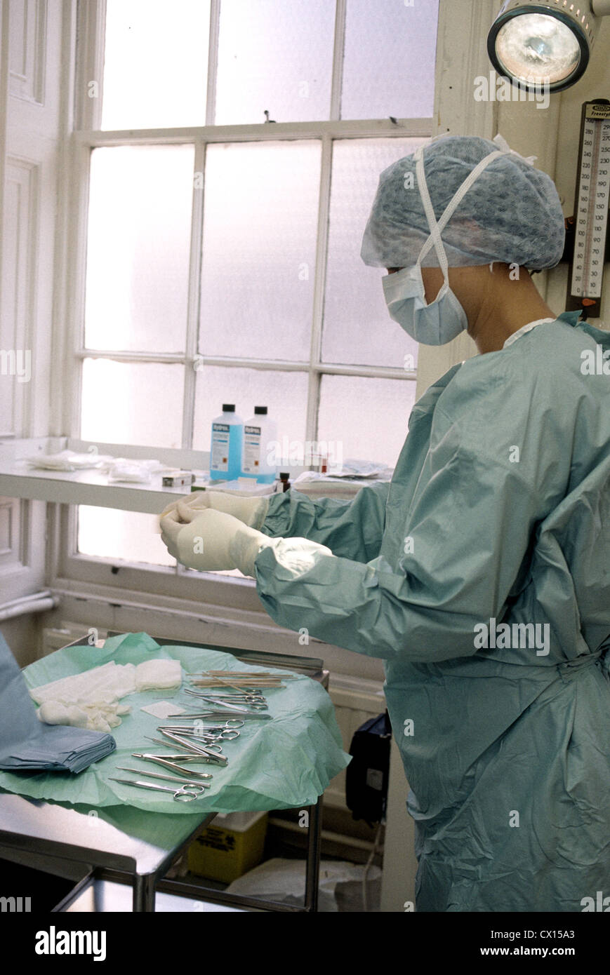 Operating room in hospital where surgeon is performing an operation on ...