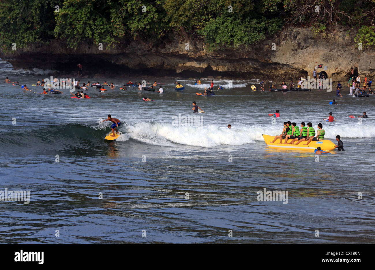 Surfing small waves during holiday season at the crowded point break of ...