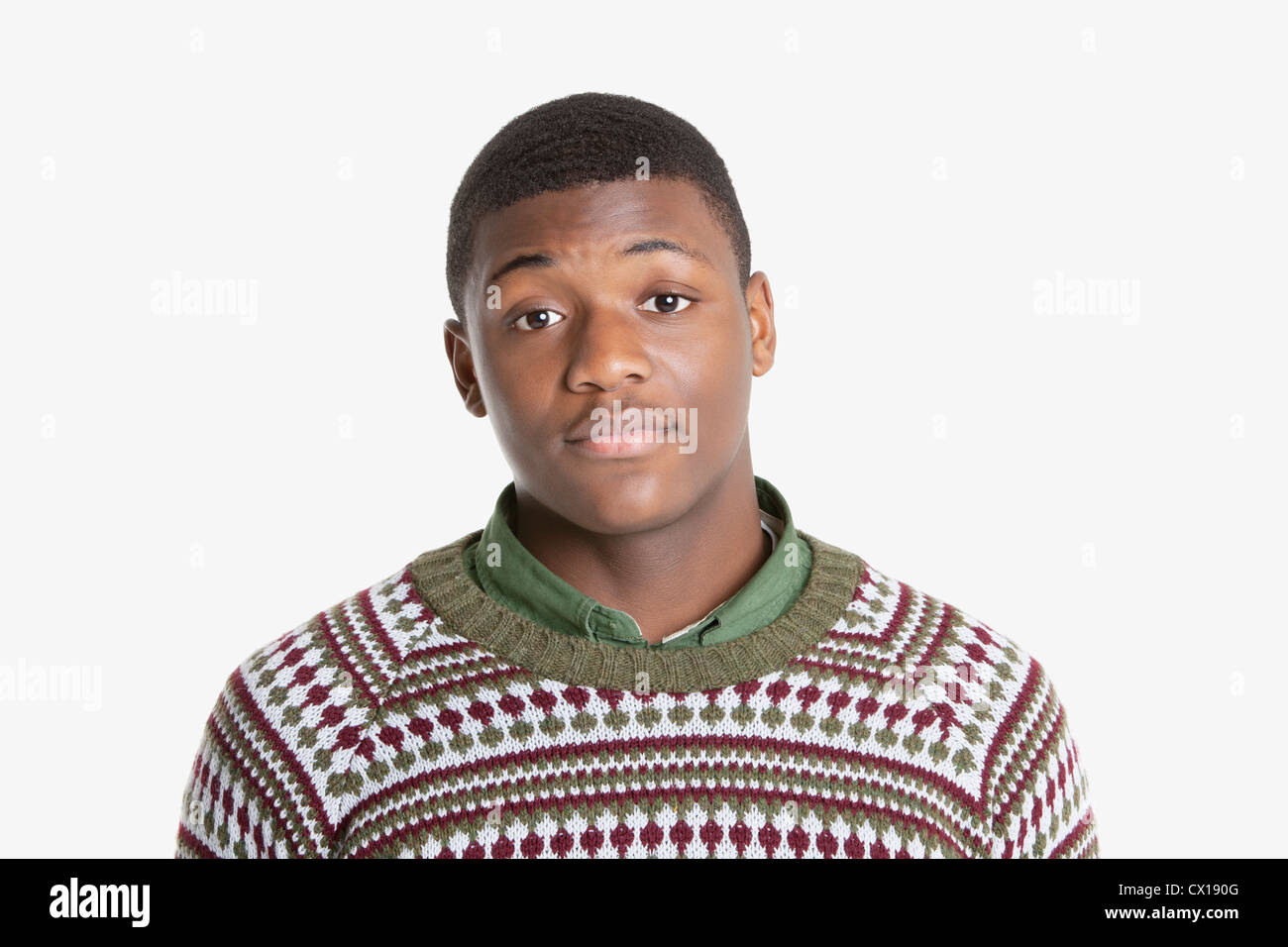 Portrait of an African American young man in sweater over gray ...