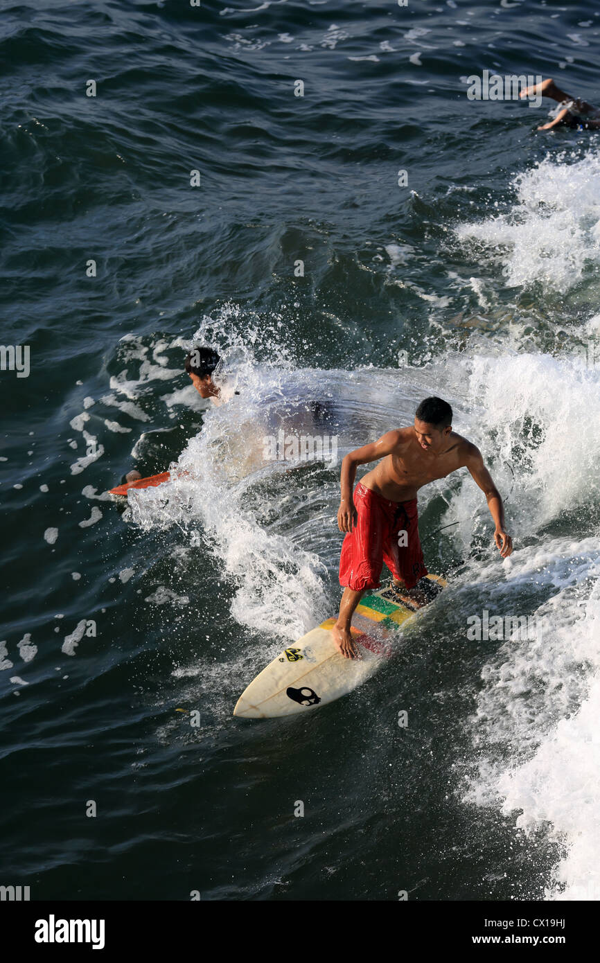 Local surfer surfing at Batu Karas in West Java, Indonesia Stock Photo ...