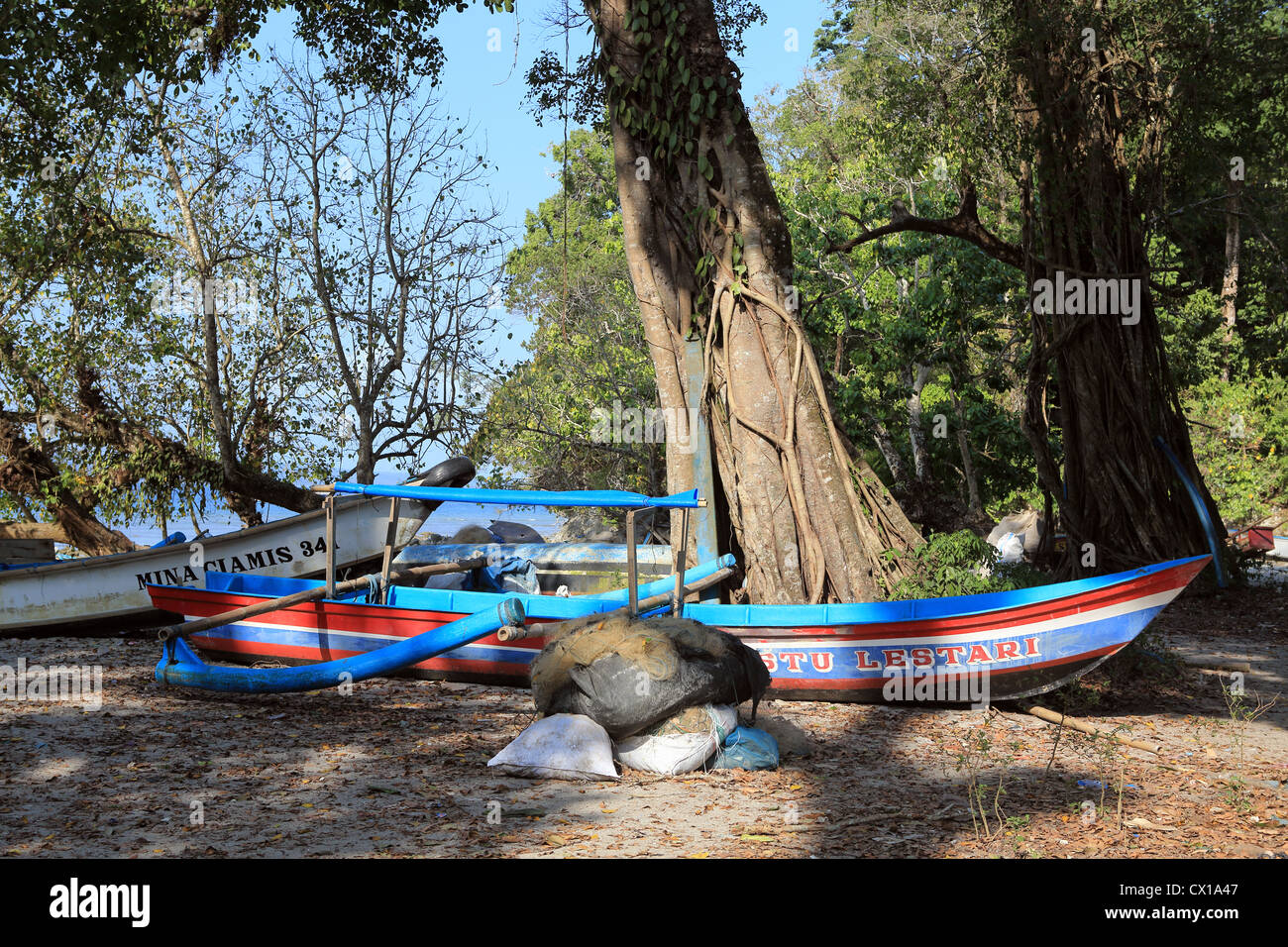 Fishing boat under trees hi-res stock photography and images - Alamy