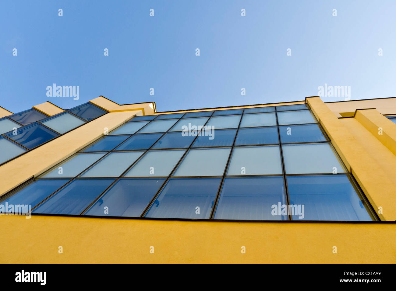 windows in a modern yellow building Stock Photo - Alamy