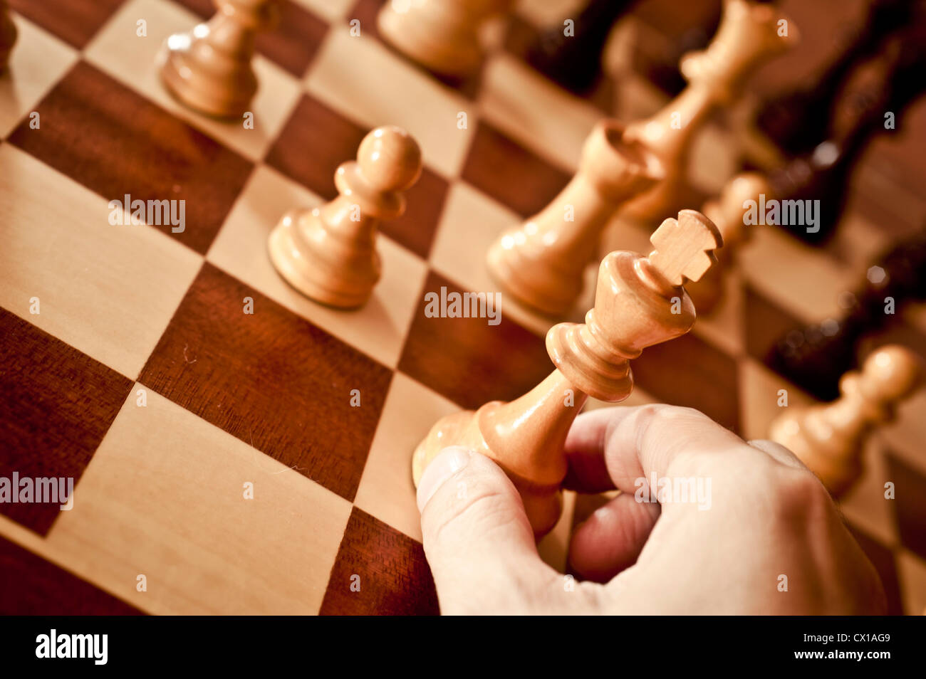 hand playing a king move during a chess game Stock Photo - Alamy