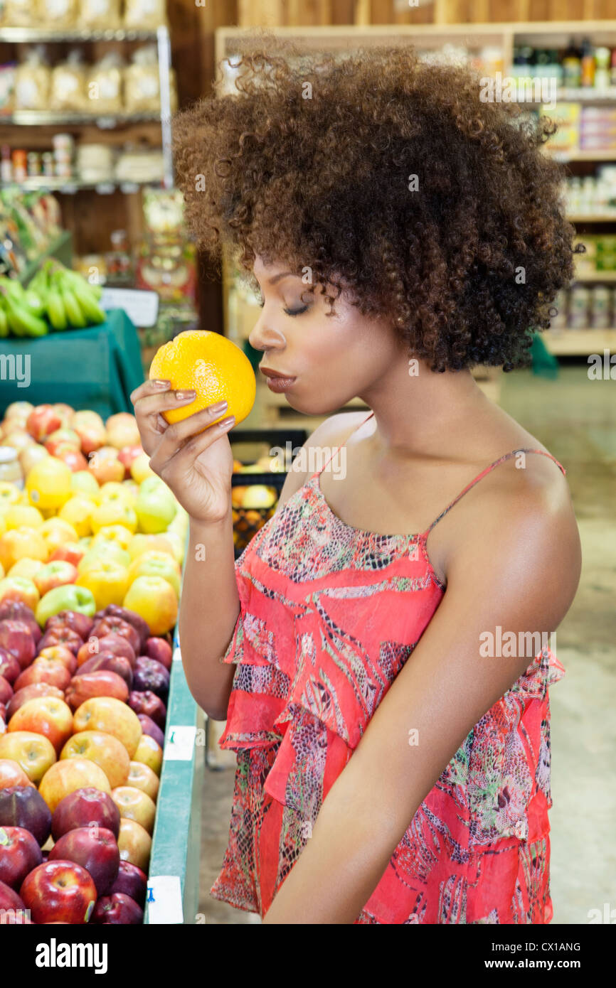 Woman smelling orange fruit hi-res stock photography and images - Alamy