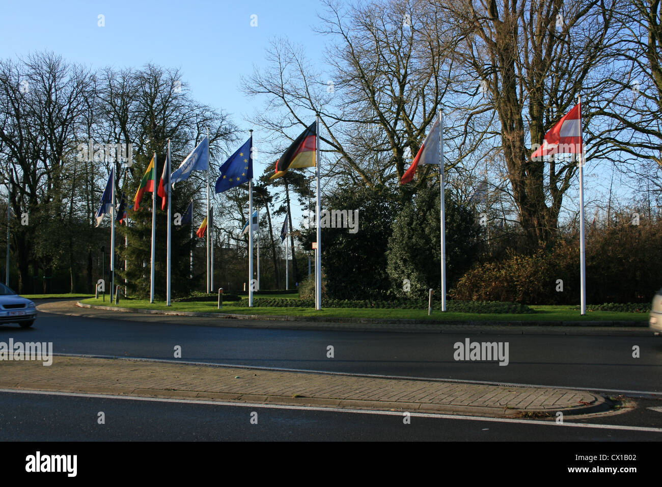 Empty Road, Flags Flying ,Trees and Blue SKy Stock Photo - Alamy