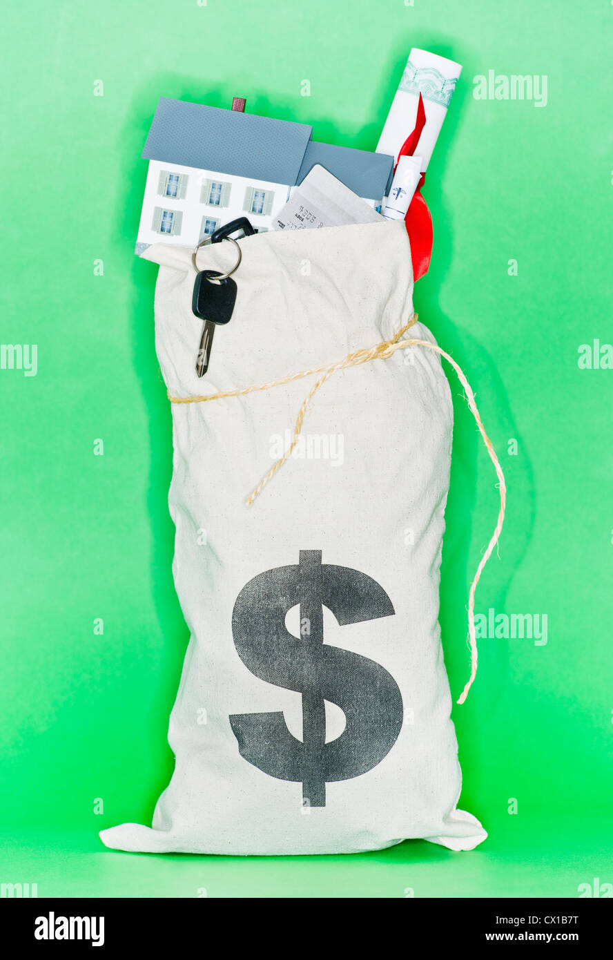 Studio shot of money bag filled with symbols of human expenses Stock ...