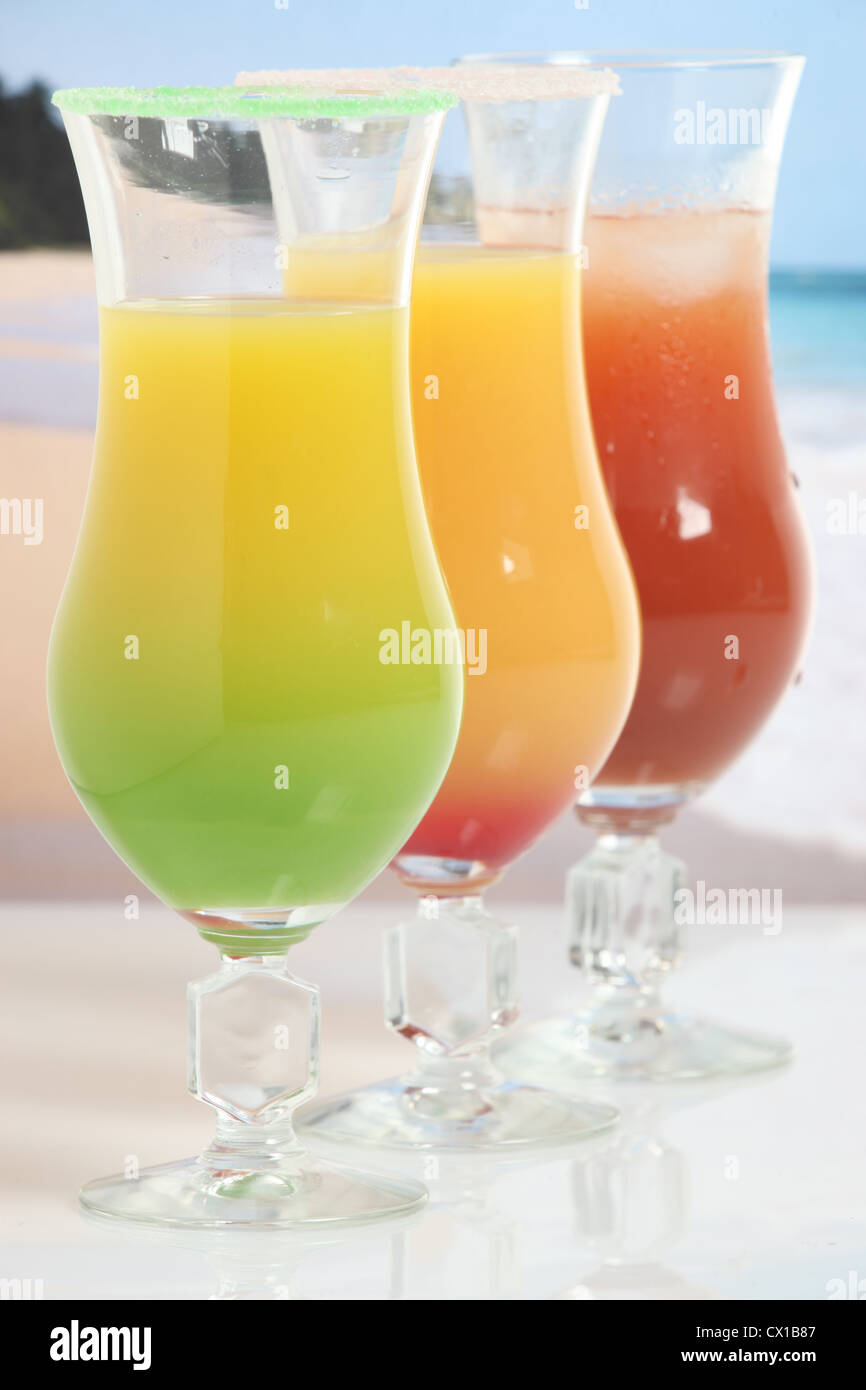 Three cocktails on beach Stock Photo - Alamy
