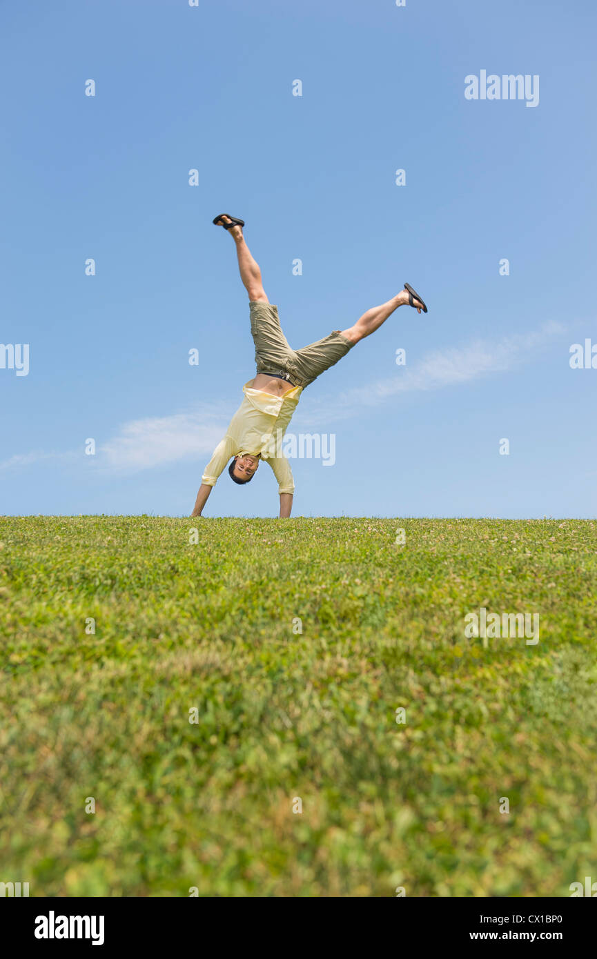 USA, New Jersey, Mendham, Man doing cartwheel on meadow Stock Photo - Alamy