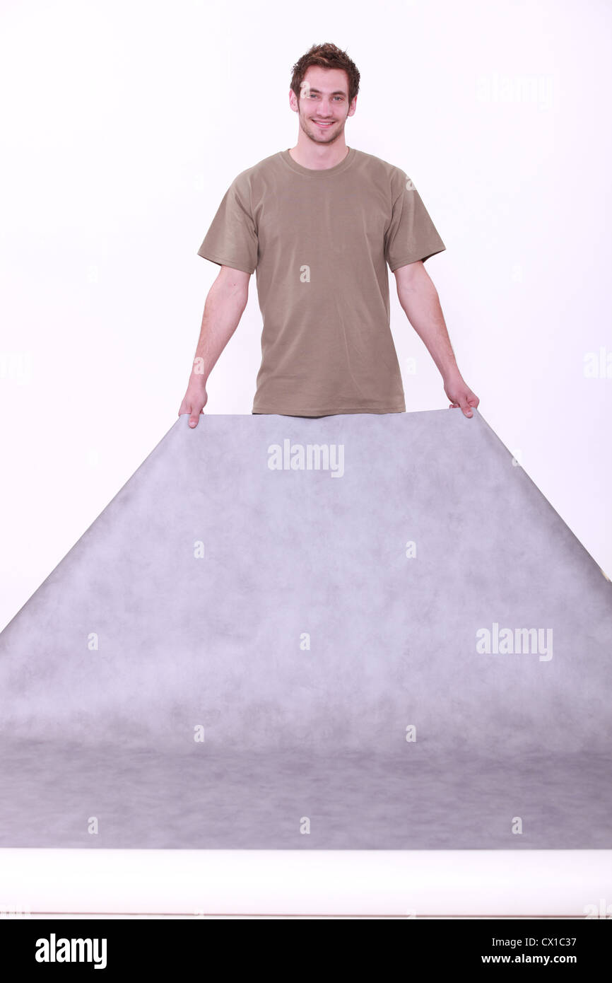 Young man laying carpet Stock Photo - Alamy