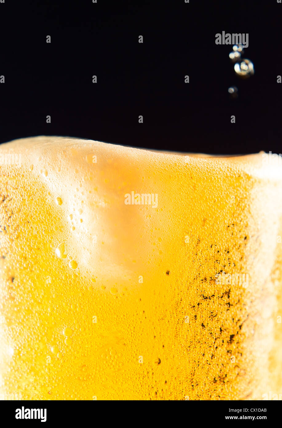 Beer mug with froth over black background Stock Photo - Alamy