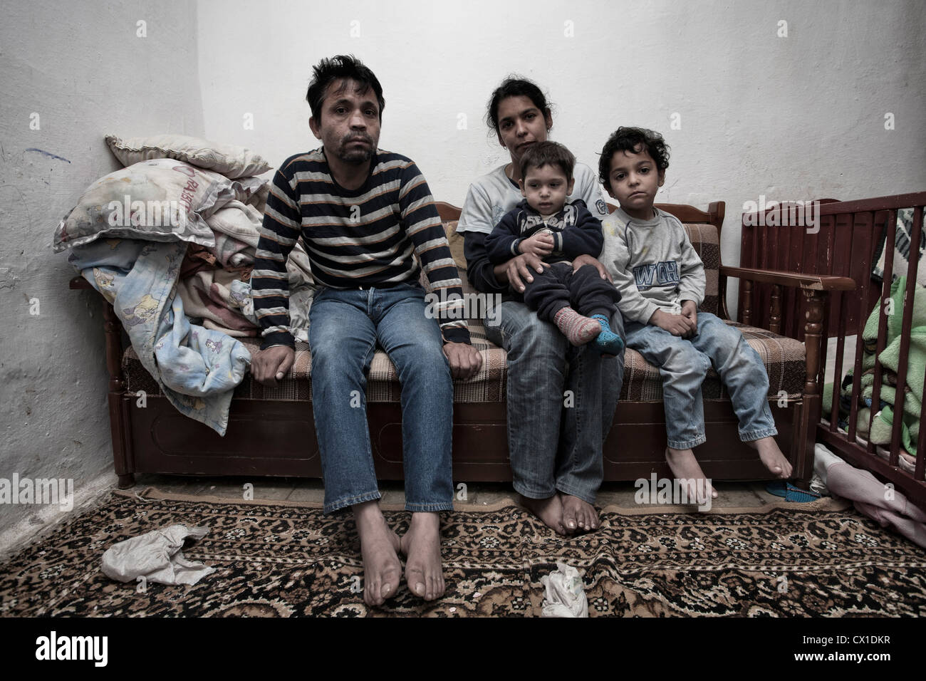 A family on the couch in their home in one of the poorest part of ...