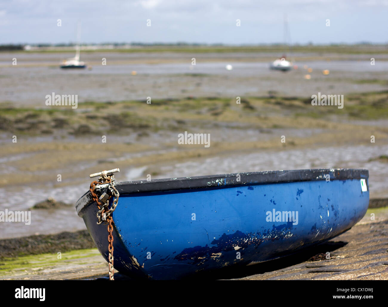 Blue rowing boat chained, at Langstone harbour Stock Photo - Alamy