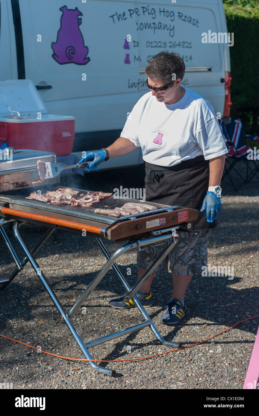 Woman cooking bacon on a BBQ at a country show Stock Photo - Alamy