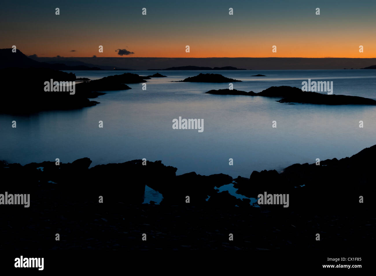 Seil Island looking out to the Garvellachs with Fladda lighthouse in ...